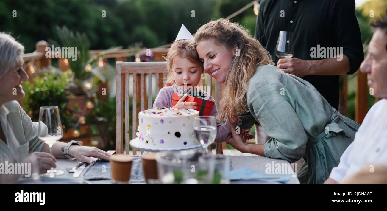 Multi generation family celebrating birthday of little girl and having ...