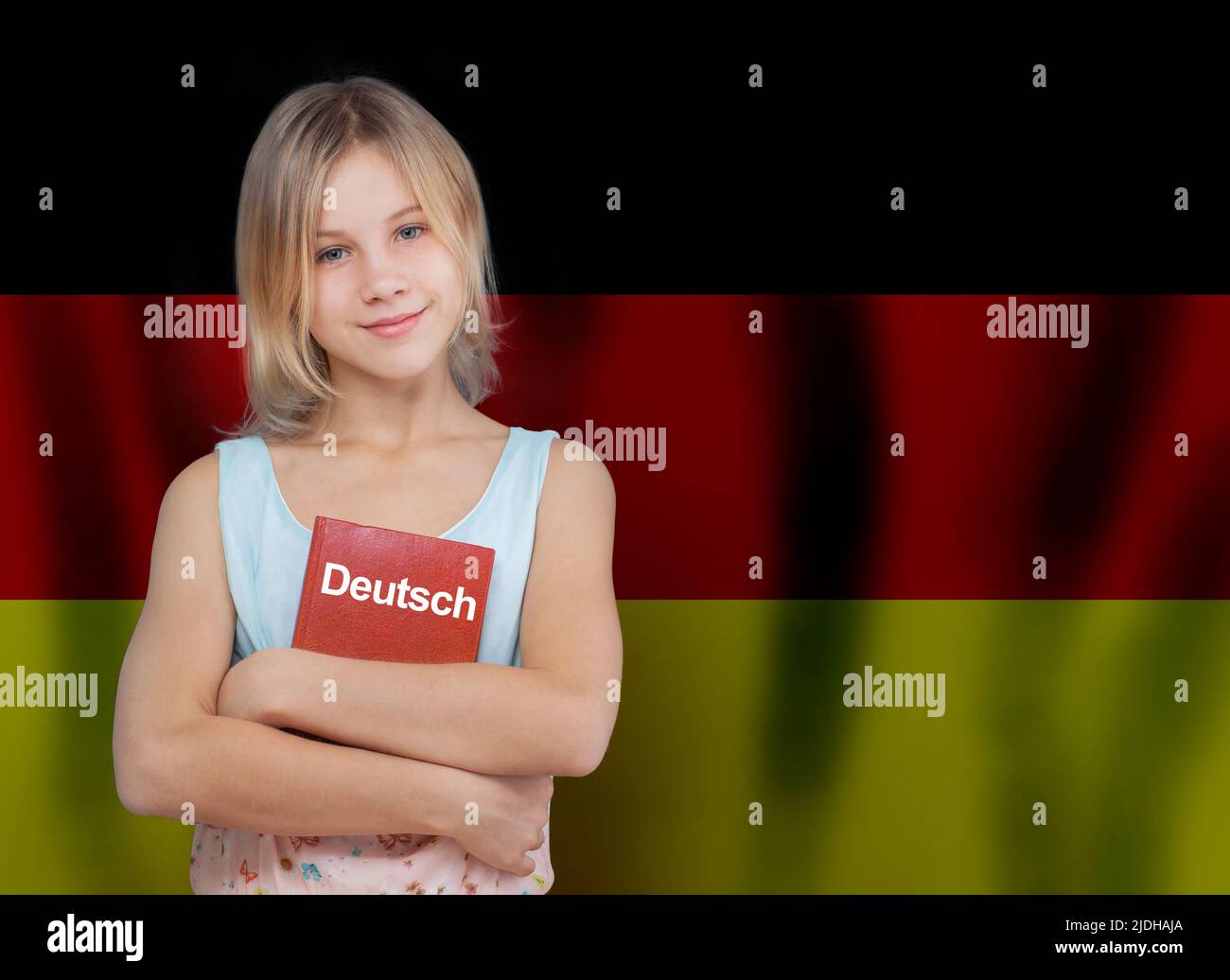 Learn German language concept. Beautiful young girl holding book with ...