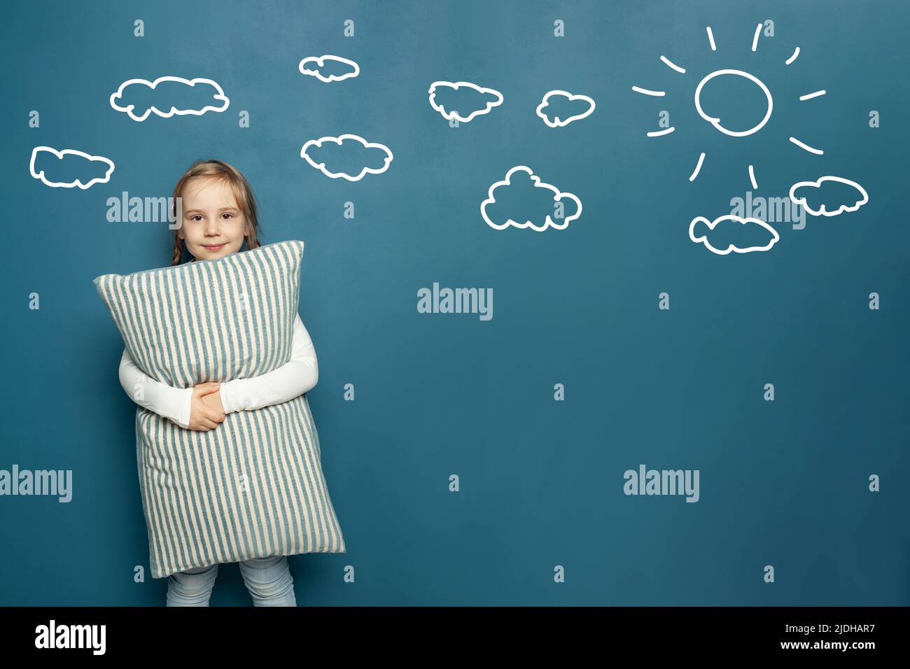 Dream, imagination and childhood concept. Little child dreaming on blue ...