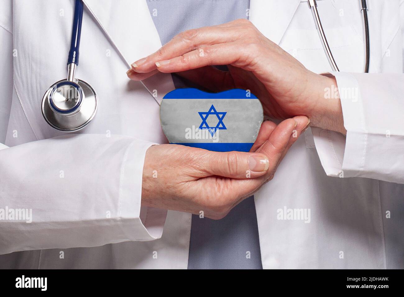 Israeli doctor holding heart with flag of Israel background. Healthcare ...