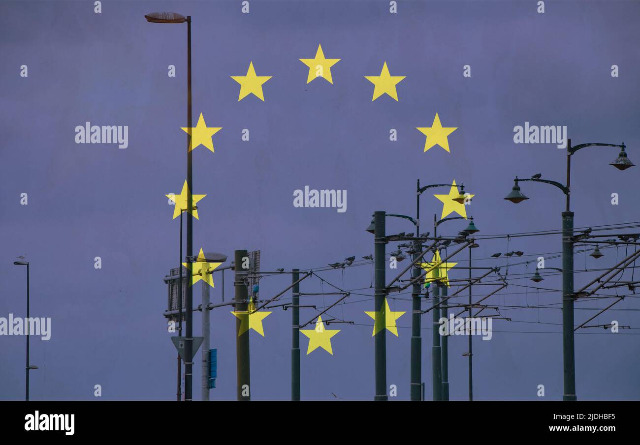 European Union flag with tram connecting on electric line with blue sky ...