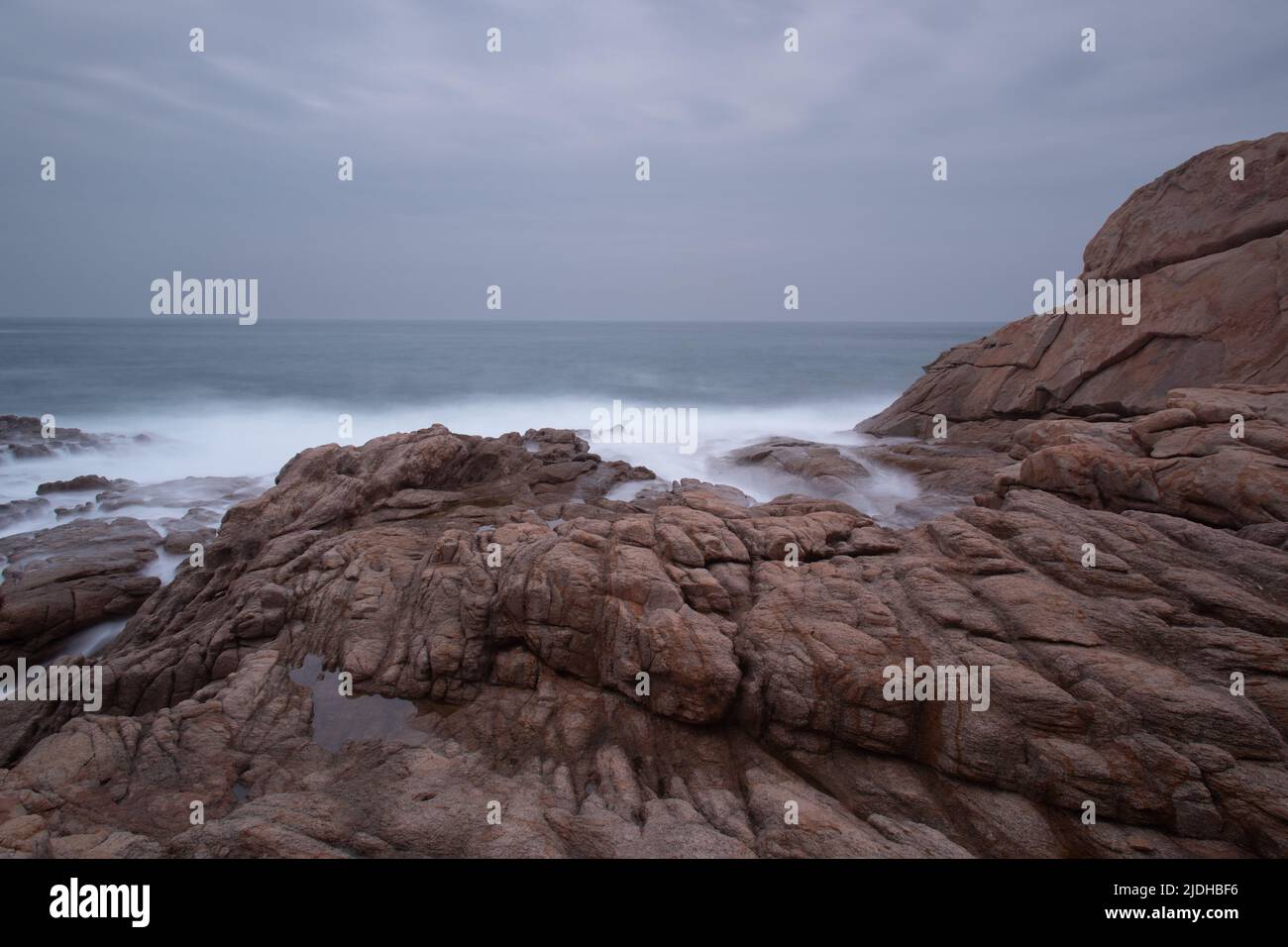 Lines in rocks lead to the breaking waves blurred by long exposure ...