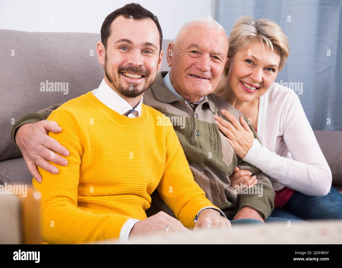 Father hugging son on sofa hi-res stock photography and images - Alamy