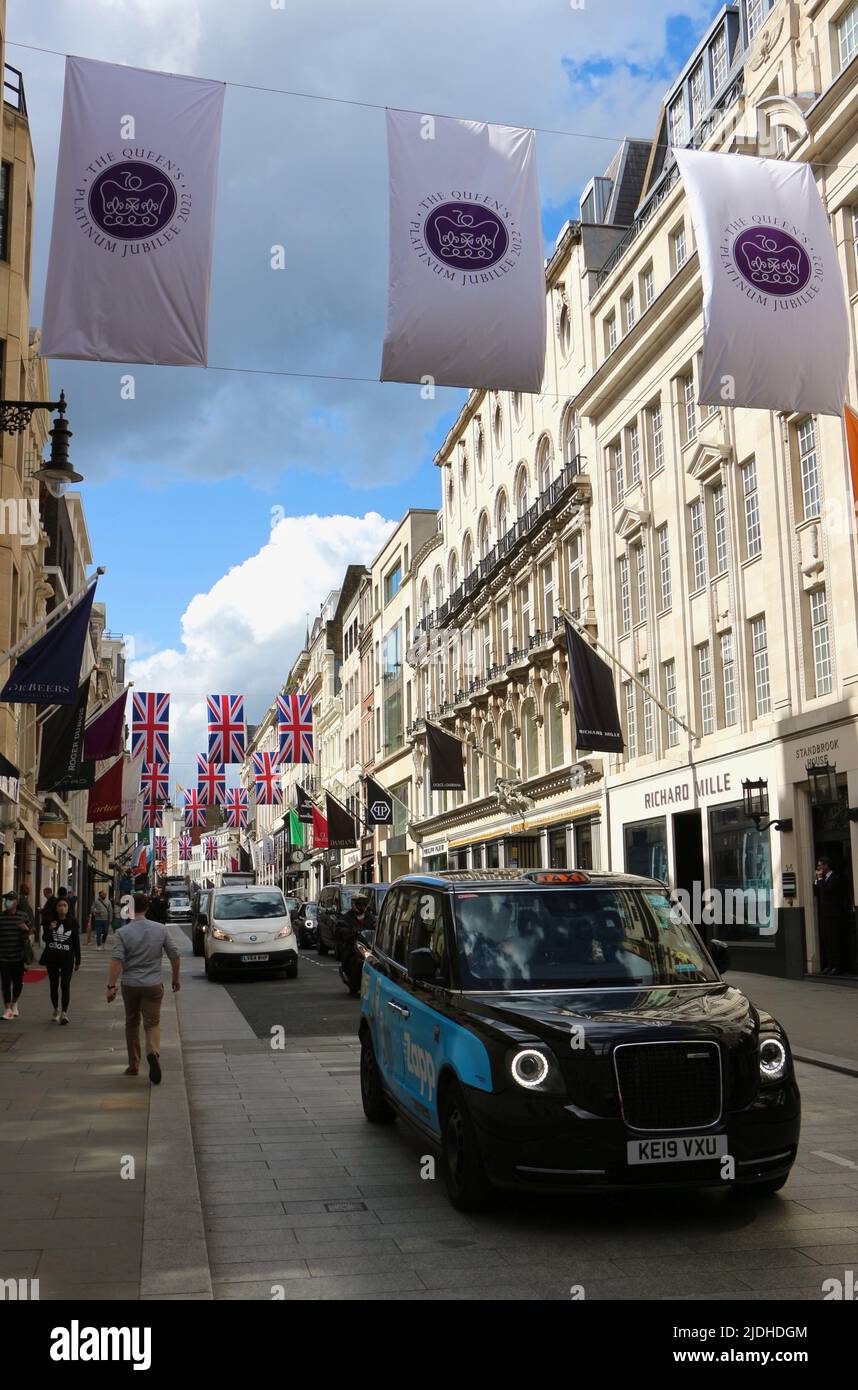 Bond Street London England UK London black taxi with union jack flags ...