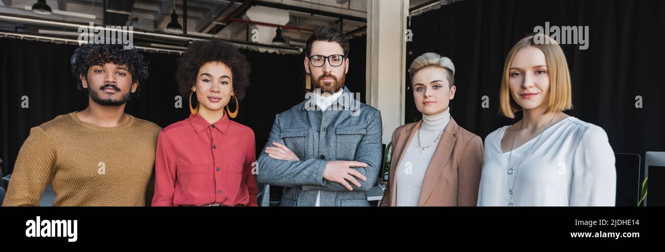 multiethnic business team in casual clothes looking at camera in ...