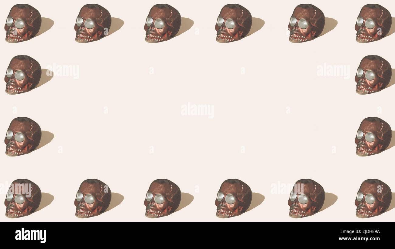 Creative frame made of brown skulls on beige background with copy space ...