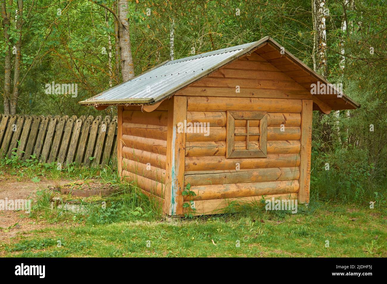 A small wooden house with a fake window on the lawn Stock Photo - Alamy