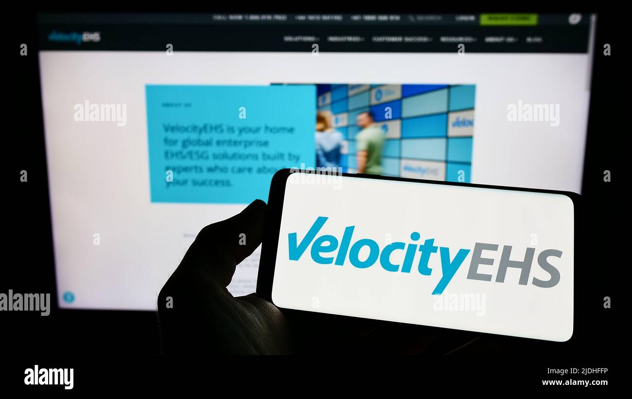 Person holding mobile phone with logo of US software company ...