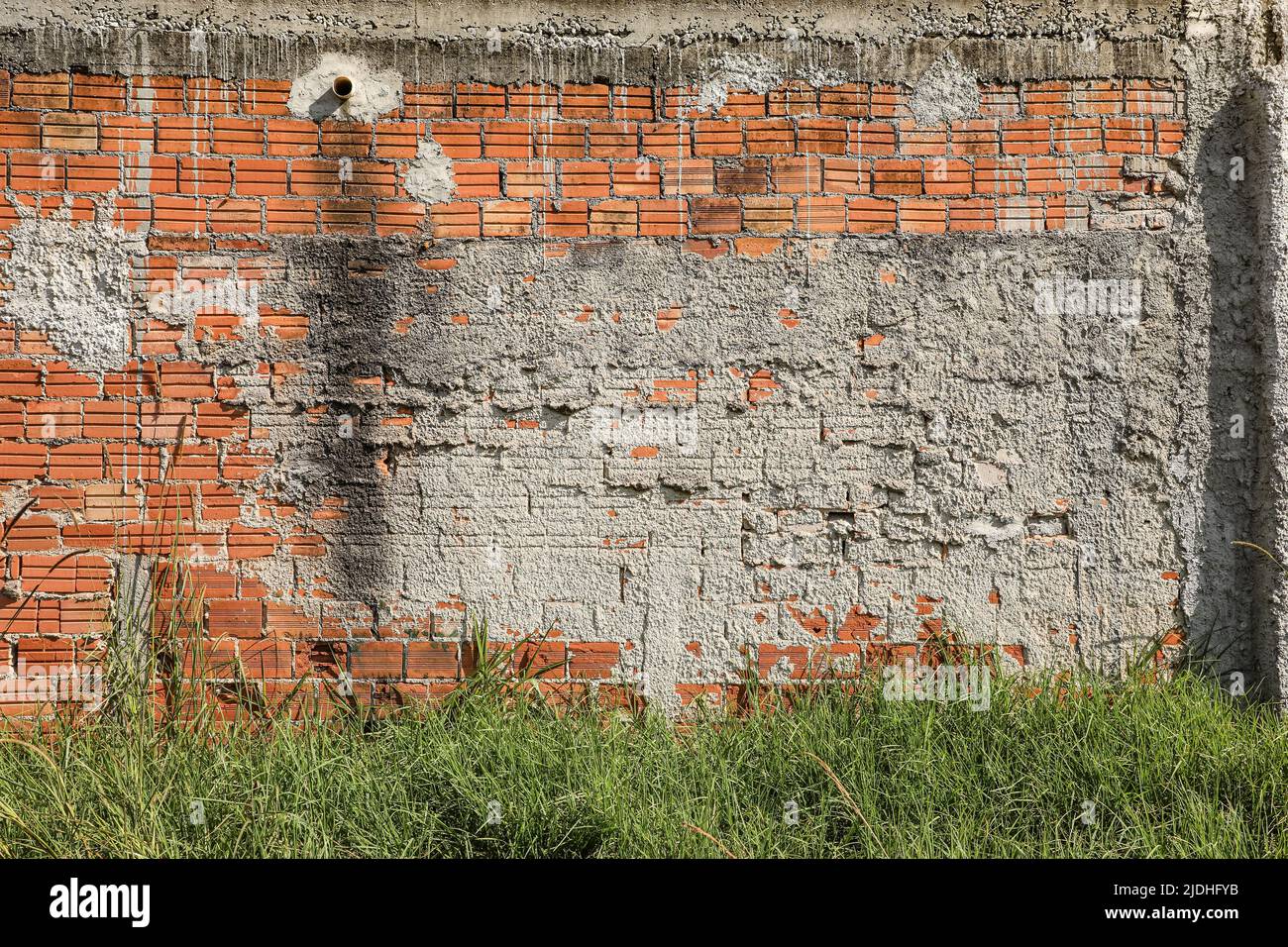 Wall mute with plaster and some exposed bricks, with signs of time ...