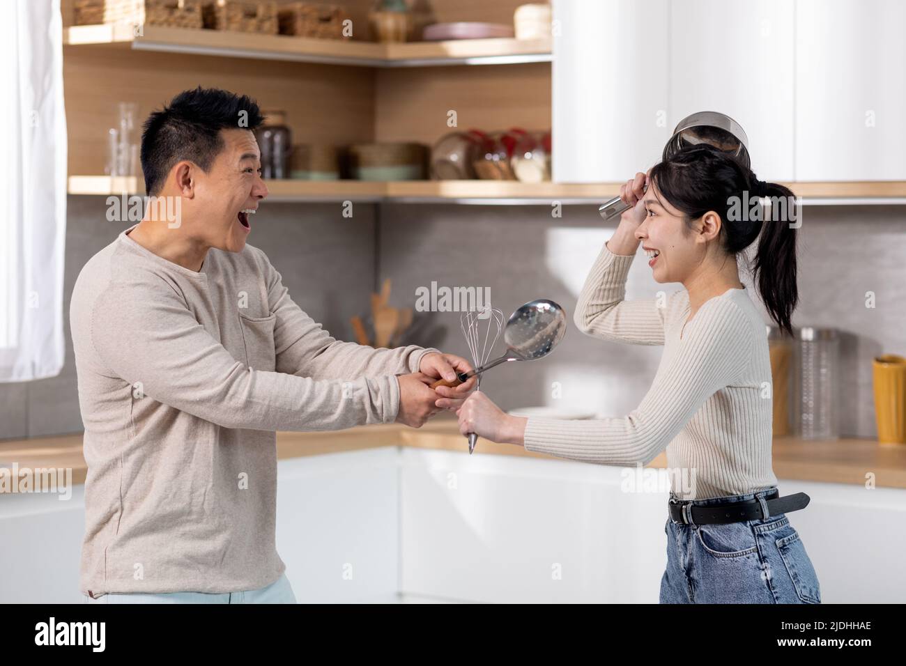 Funny japanese couple having good time while cooking together Stock ...