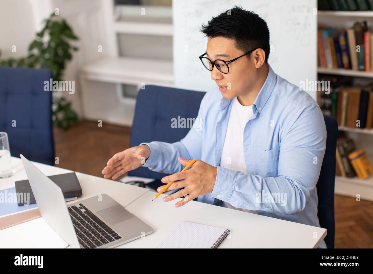 Asian man making video call hi-res stock photography and images - Alamy