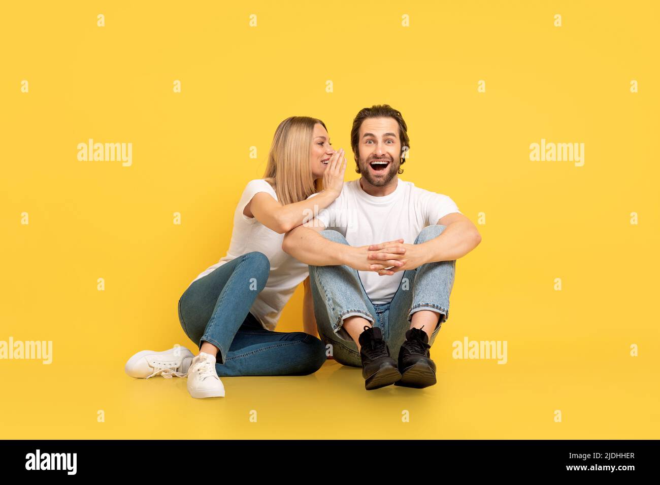 Man whispering in woman ear hi-res stock photography and images - Alamy