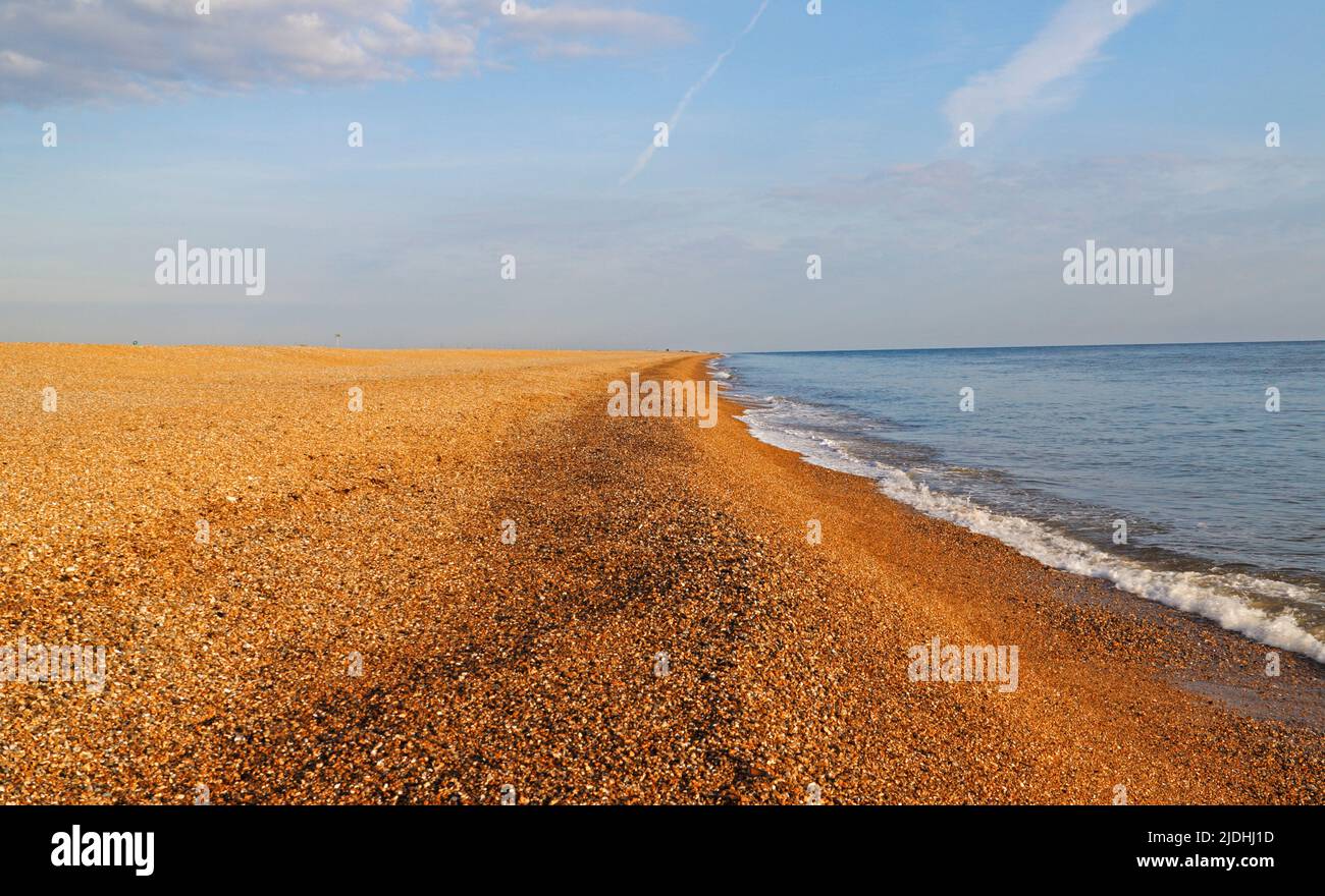 A view along the extensive shingle beach and shoreline in summer on the ...