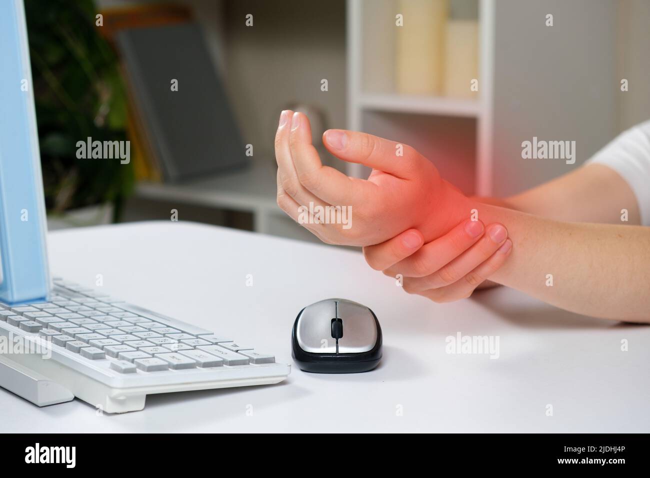 Hands of a person with carpal tunnel syndrome, a computer and a mouse ...