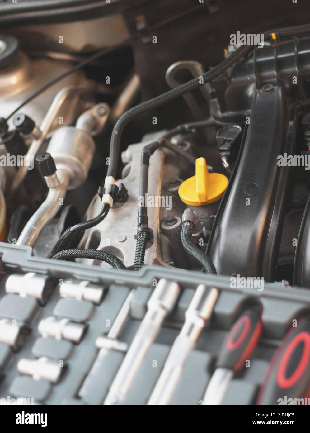 A set of socket wrenches lies on the car engine in the engine ...