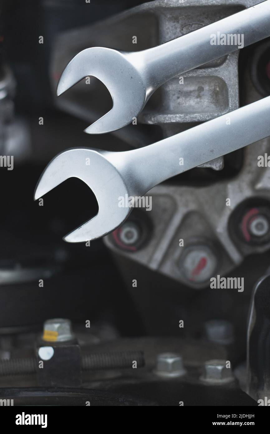 Wrenches for repairs lie on the car engine in the engine compartment ...