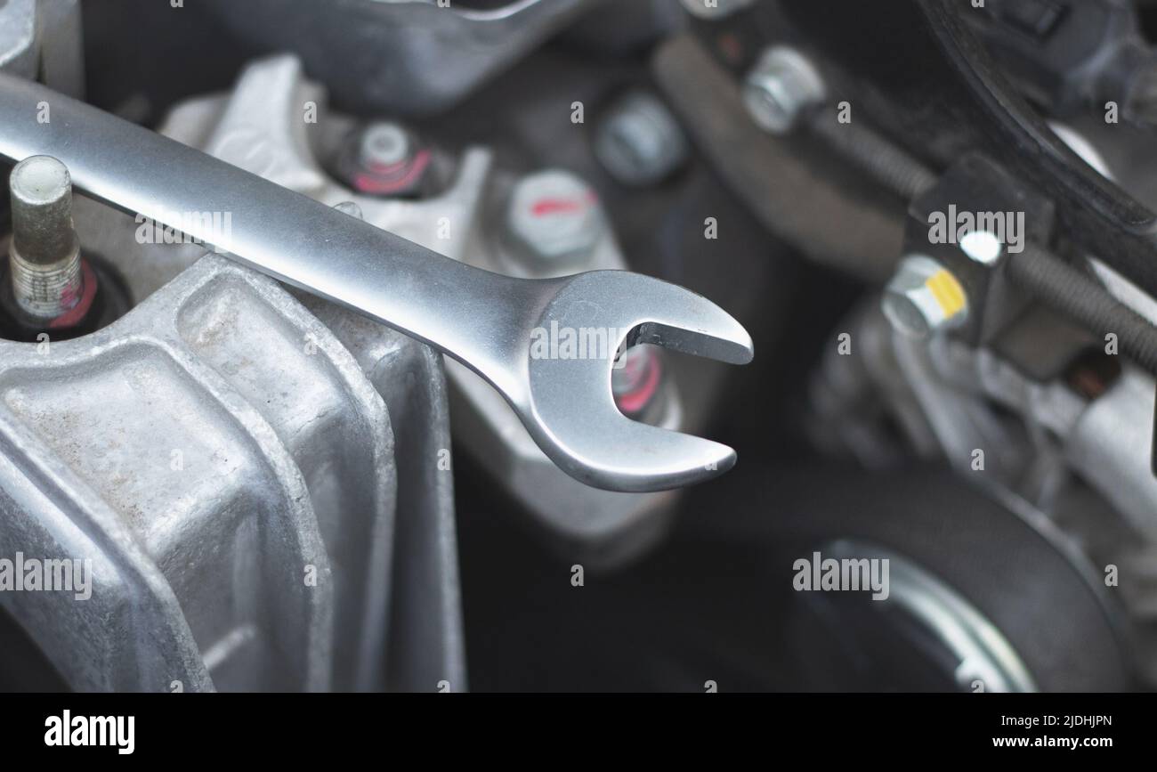 The repair wrench lies on the car engine in the engine compartment ...