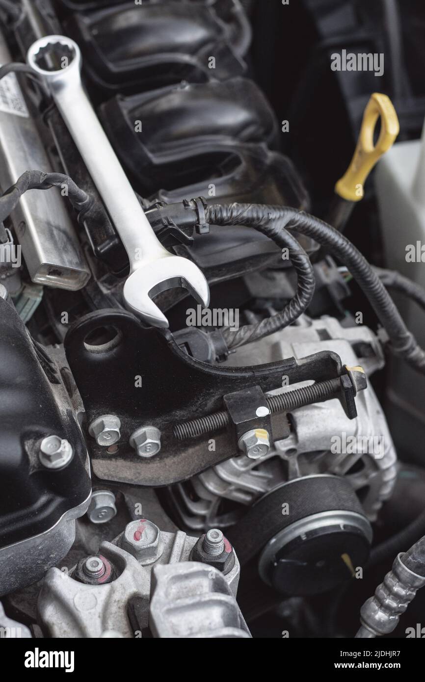 The repair wrench lies on the car engine in the engine compartment ...