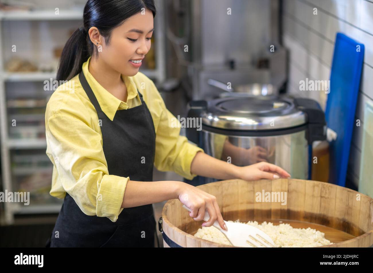 Asian woman touching food in bowl with cutlery Stock Photo - Alamy