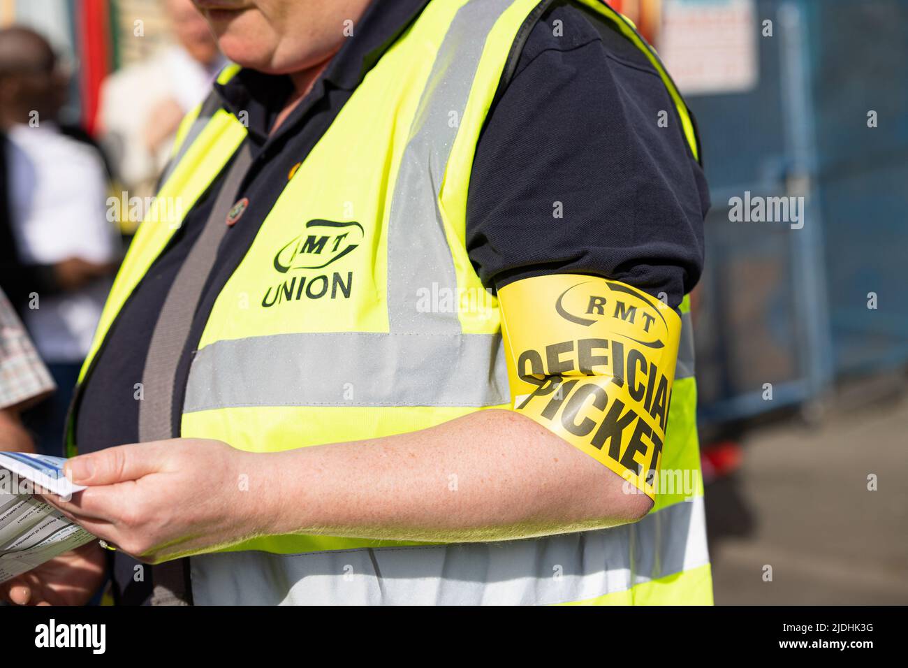 London, UK. 21st June, 2022. A member of the RMT Union is seen holding ...