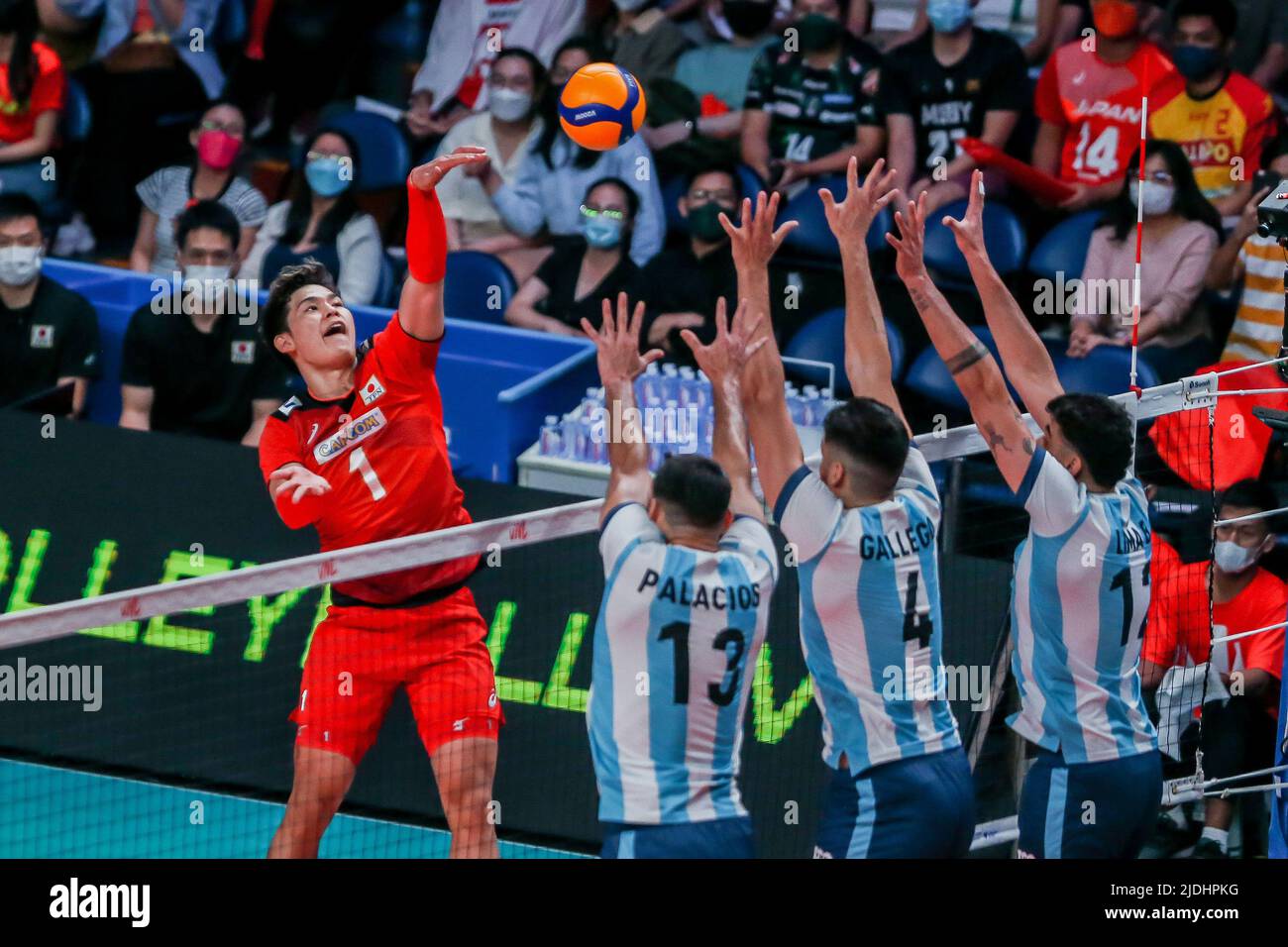 Quezon City. 21st June, 2022. Japan's Nishida Yuji (L) spikes the ball ...