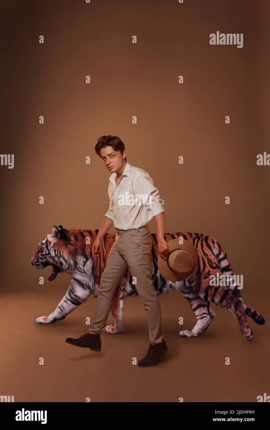 Beautiful man with tiger in studio Stock Photo - Alamy