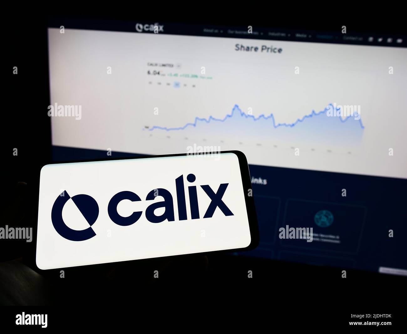 Person holding mobile phone with logo of Australian technology company ...