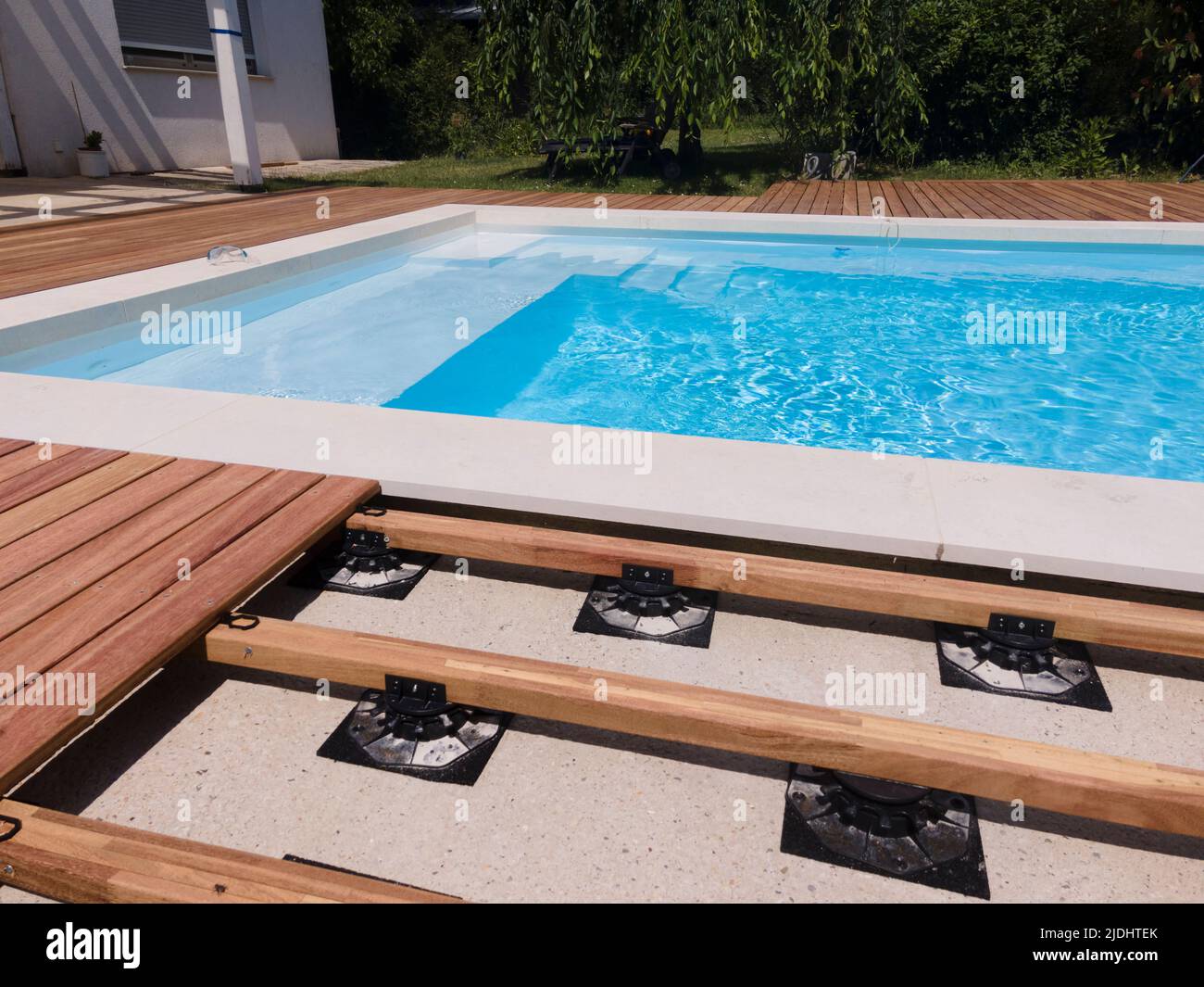 aerial drone flight over beautiful green garden with pool and the ...