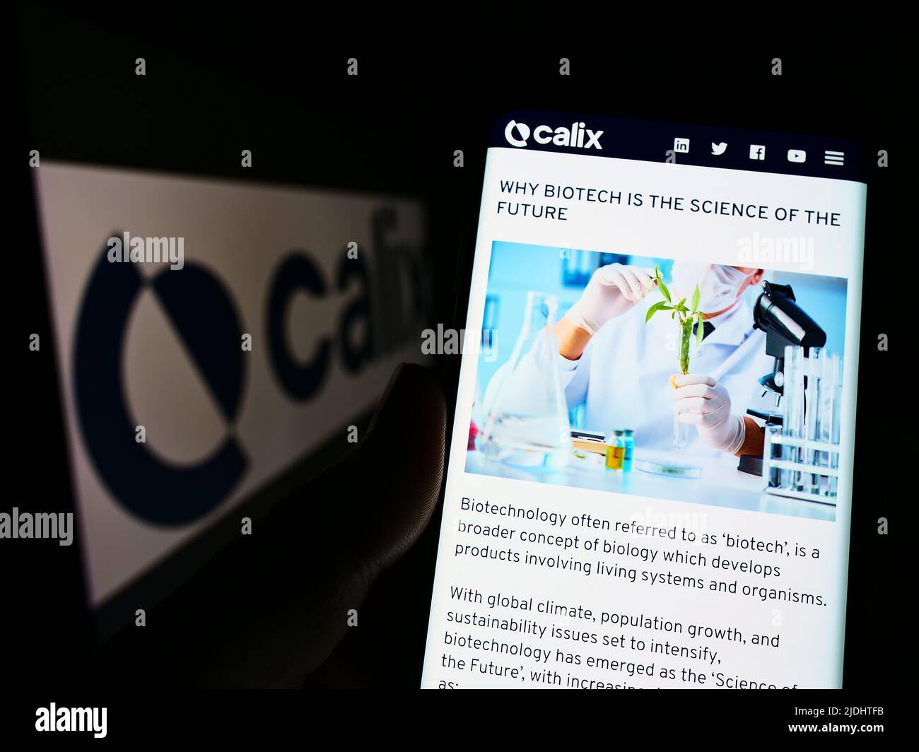 Person holding cellphone with website of Australian technology company ...