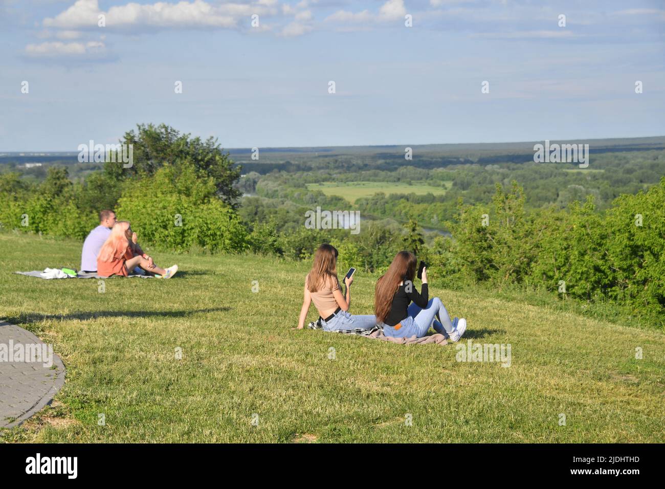 Vladimir. Young people have a rest on a lawn Stock Photo - Alamy