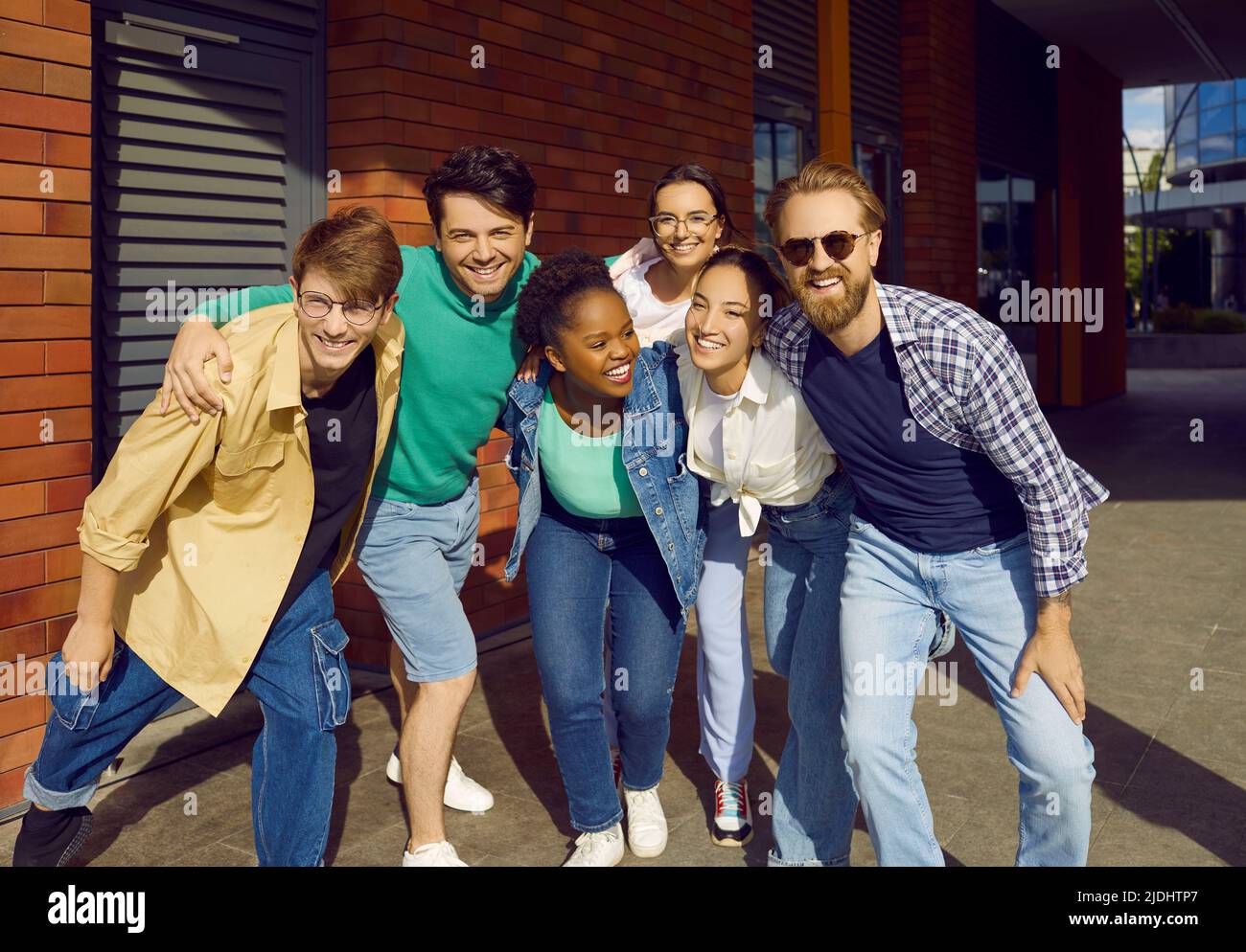 Joyful group of multiracial friends are having fun and fooling around ...