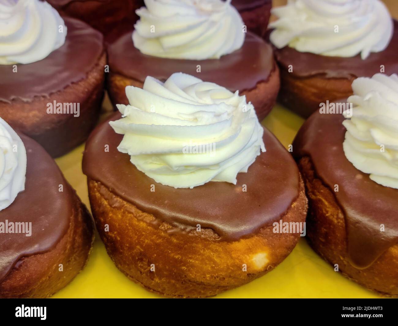 Bakery donuts with chocolate icing and white cream dollop Stock Photo ...