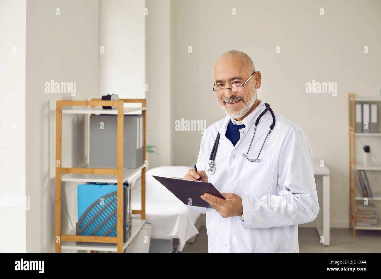 Portrait of smiling old doctor in uniform in hospital Stock Photo - Alamy