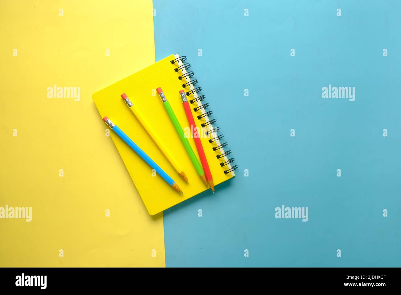high angle view of color notepad and pencils on color background Stock ...