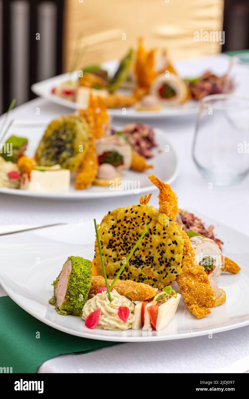 Various kind of starter dishes on restaurant table ready to eat Stock ...