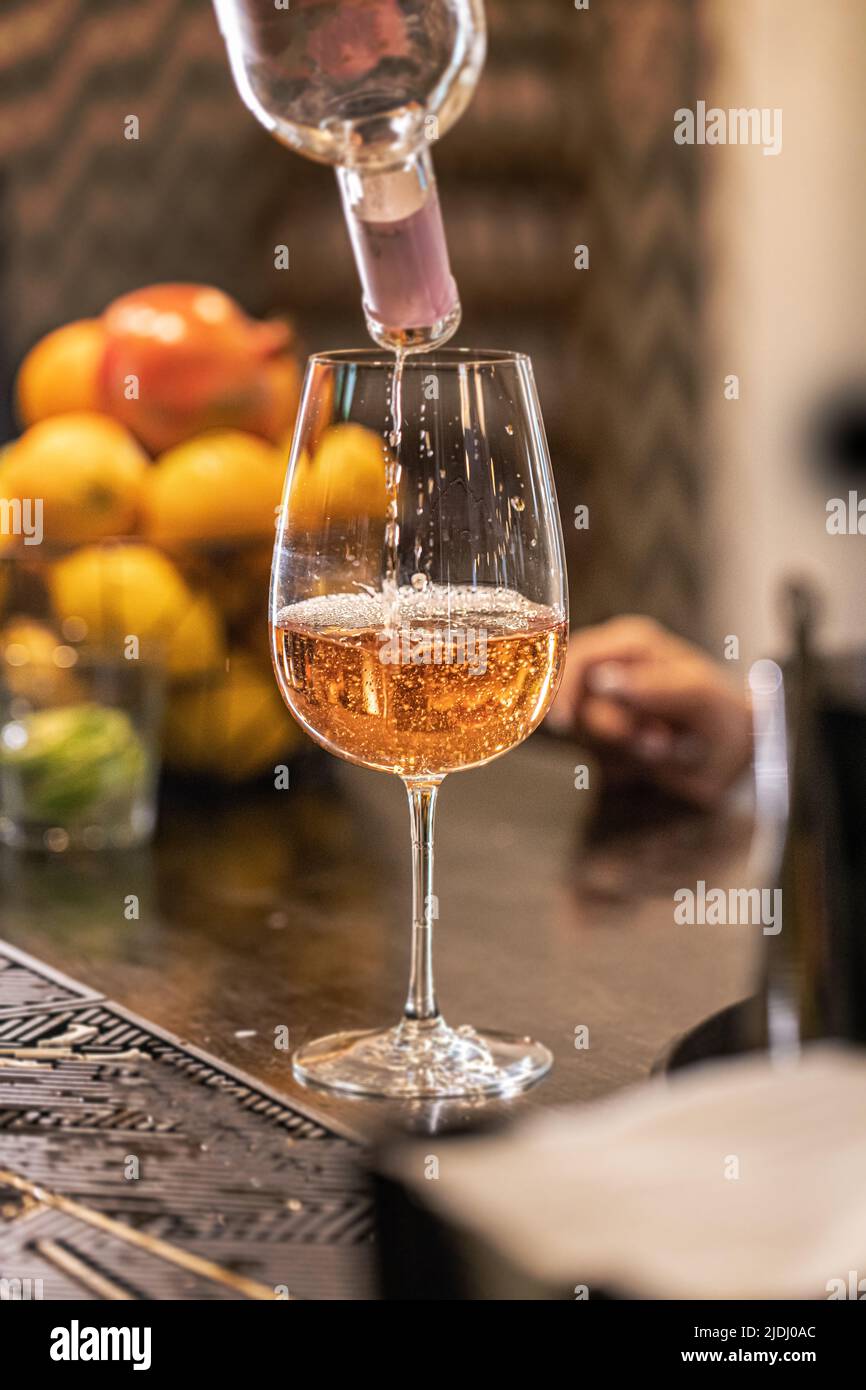 Bartender pouring prosecco in wine glass. Long fizzy drink Stock Photo ...