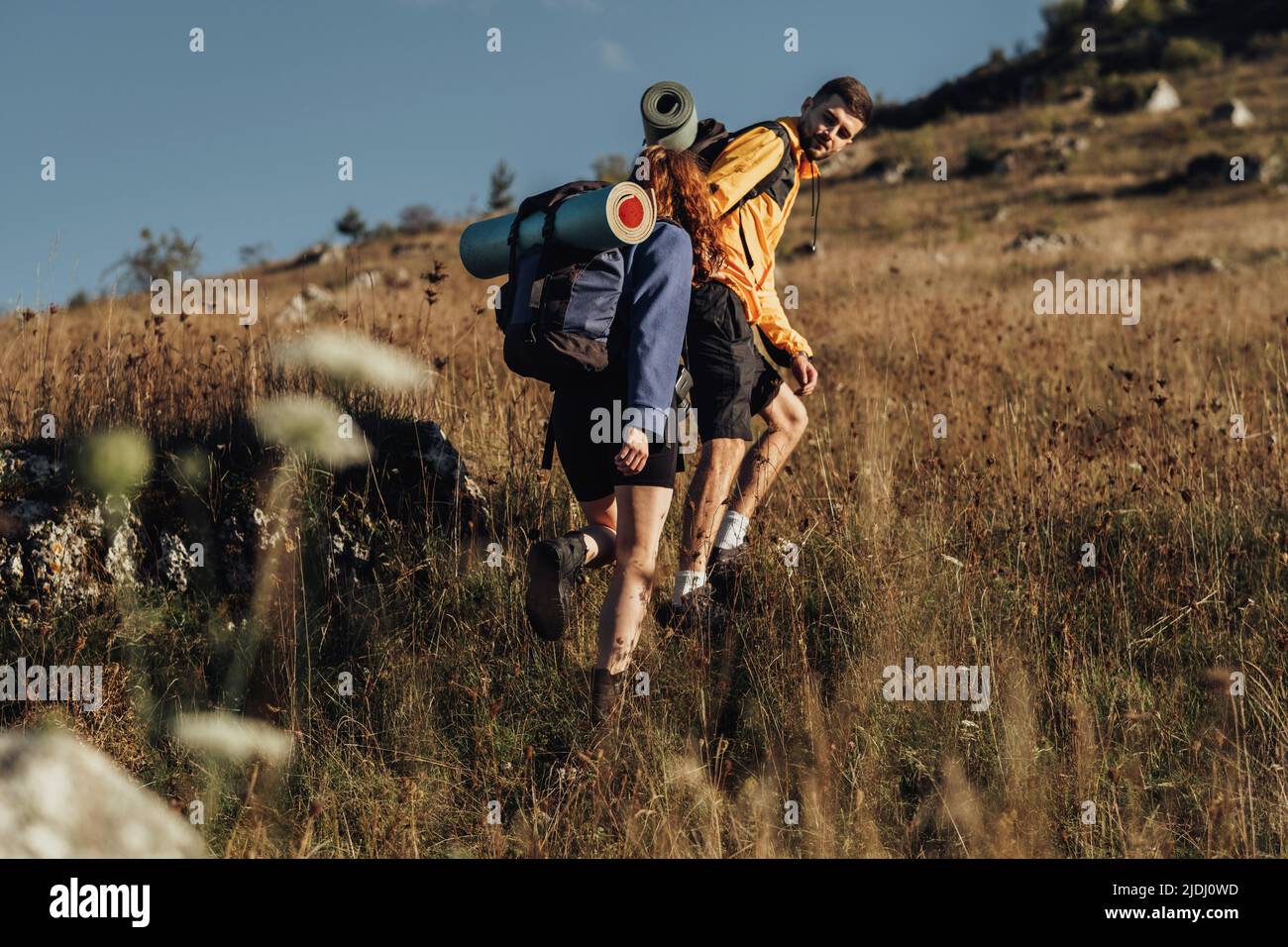 Two Travelers with Backpacks and Camping Mat on a Route, Man Helping ...