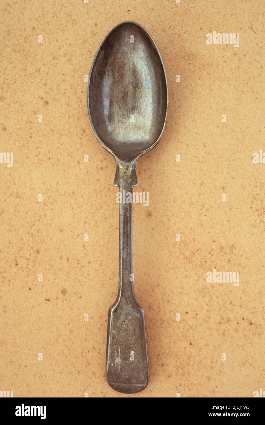 Antique tarnished silver teaspoon lying on antique paper Stock Photo ...
