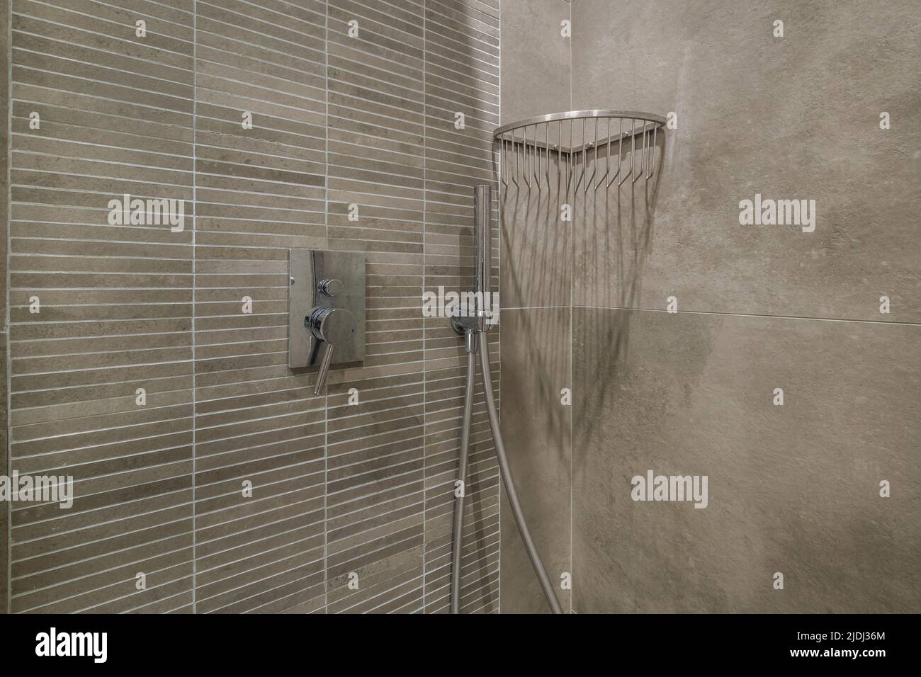 toilet and detail of a corner shower cabin with wall mount shower ...