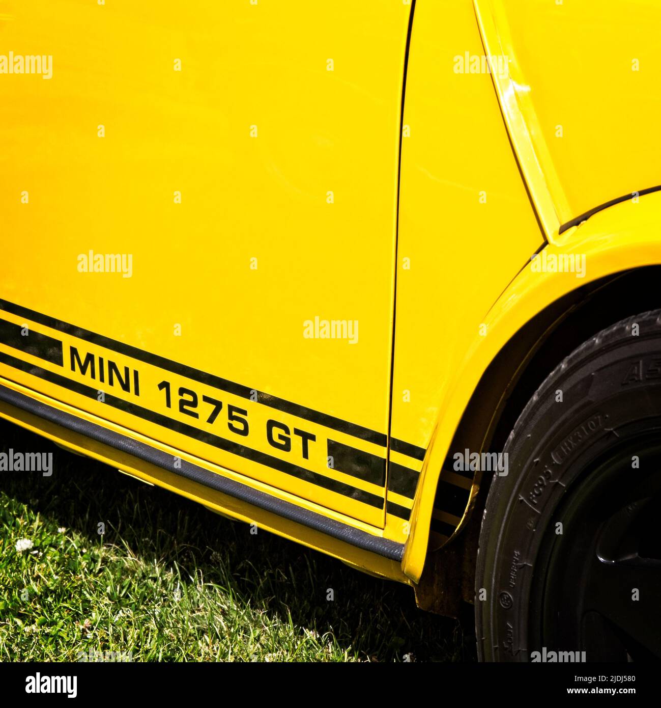 Close up detail of a bright yellow Mini 1275 GT classic vintage motor ...