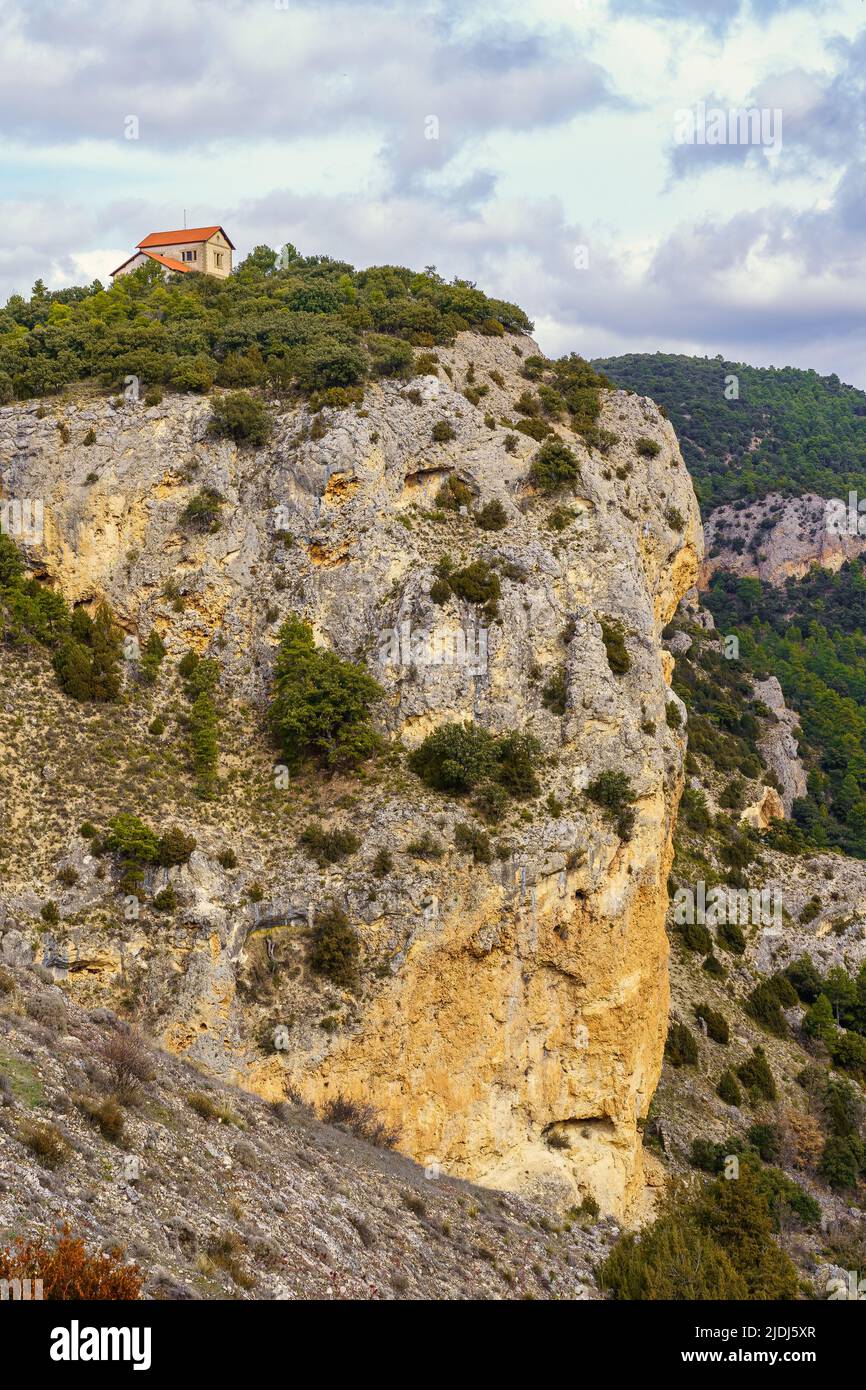 Huge rock cliff with a little house on top of the mountain Stock Photo ...