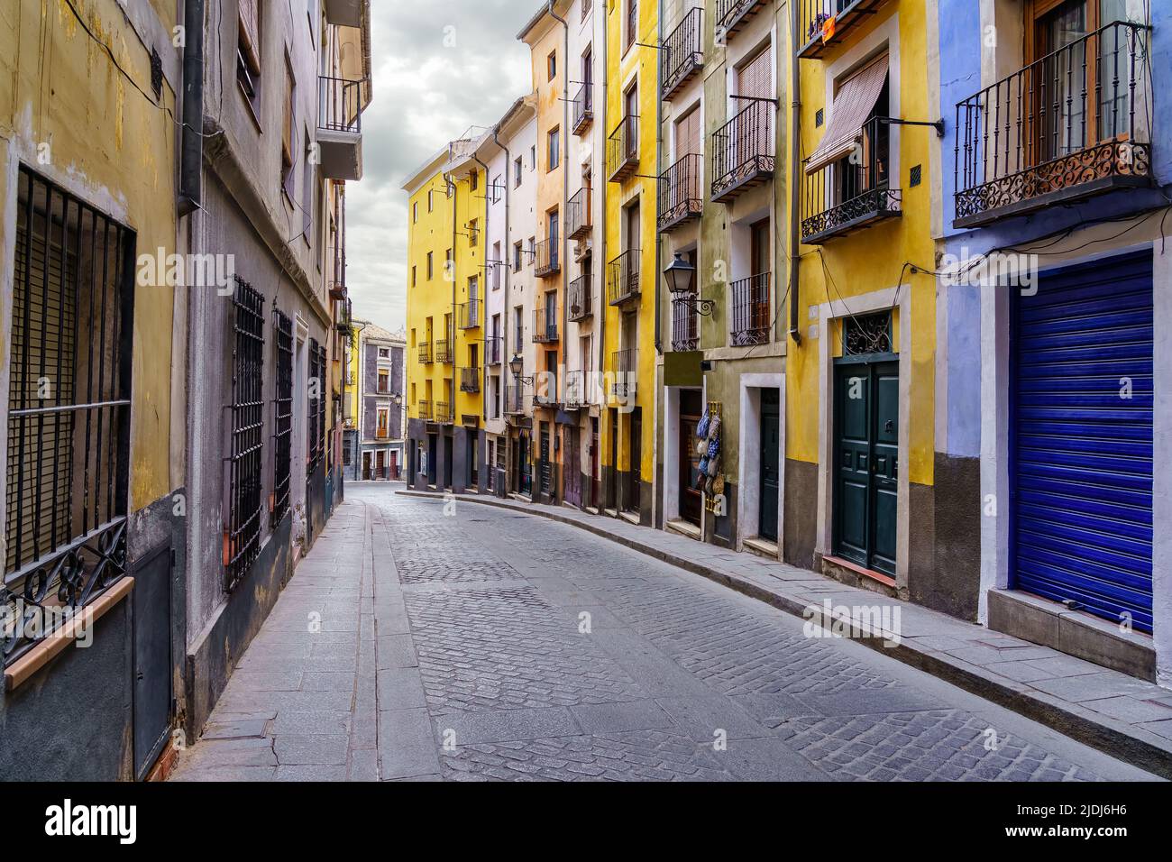 Narrow alley with colorful houses in the World Heritage city of Cuenca ...