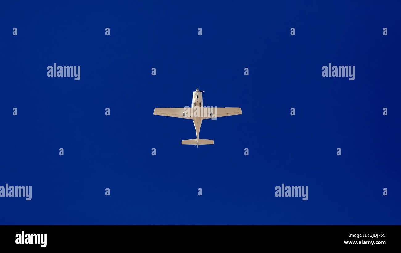 Prop Plane Flying Through Deep Blue Sky Stock Photo - Alamy