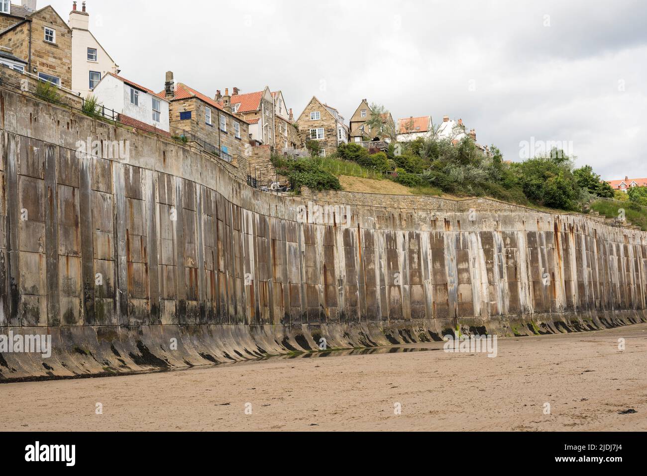 High vertical concrete sea wall, Robbin Hood's Bay, North Yorkshire ...