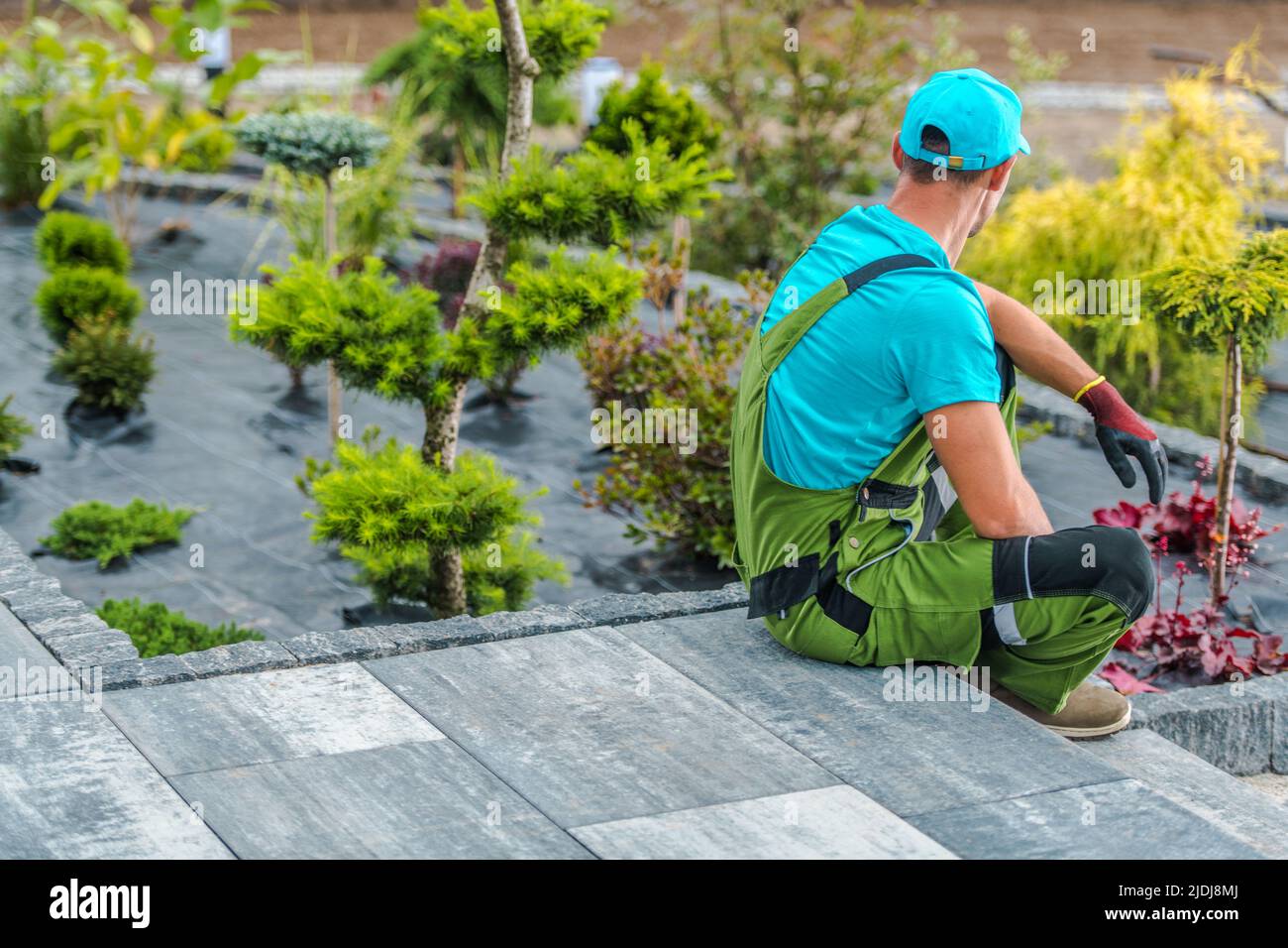 Caucasian Male Gardener Sitting on the Terrace of His Client’s Backyard ...