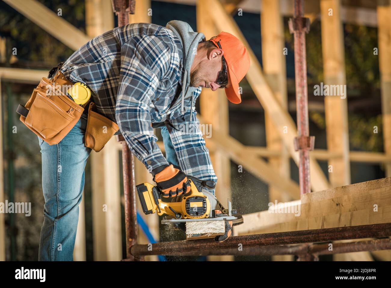 Portable Circular Saw In Action at the Wooden House Skeleton ...