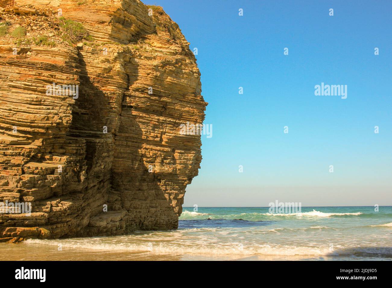 a day on the beach among the rocks and cold water Stock Photo - Alamy