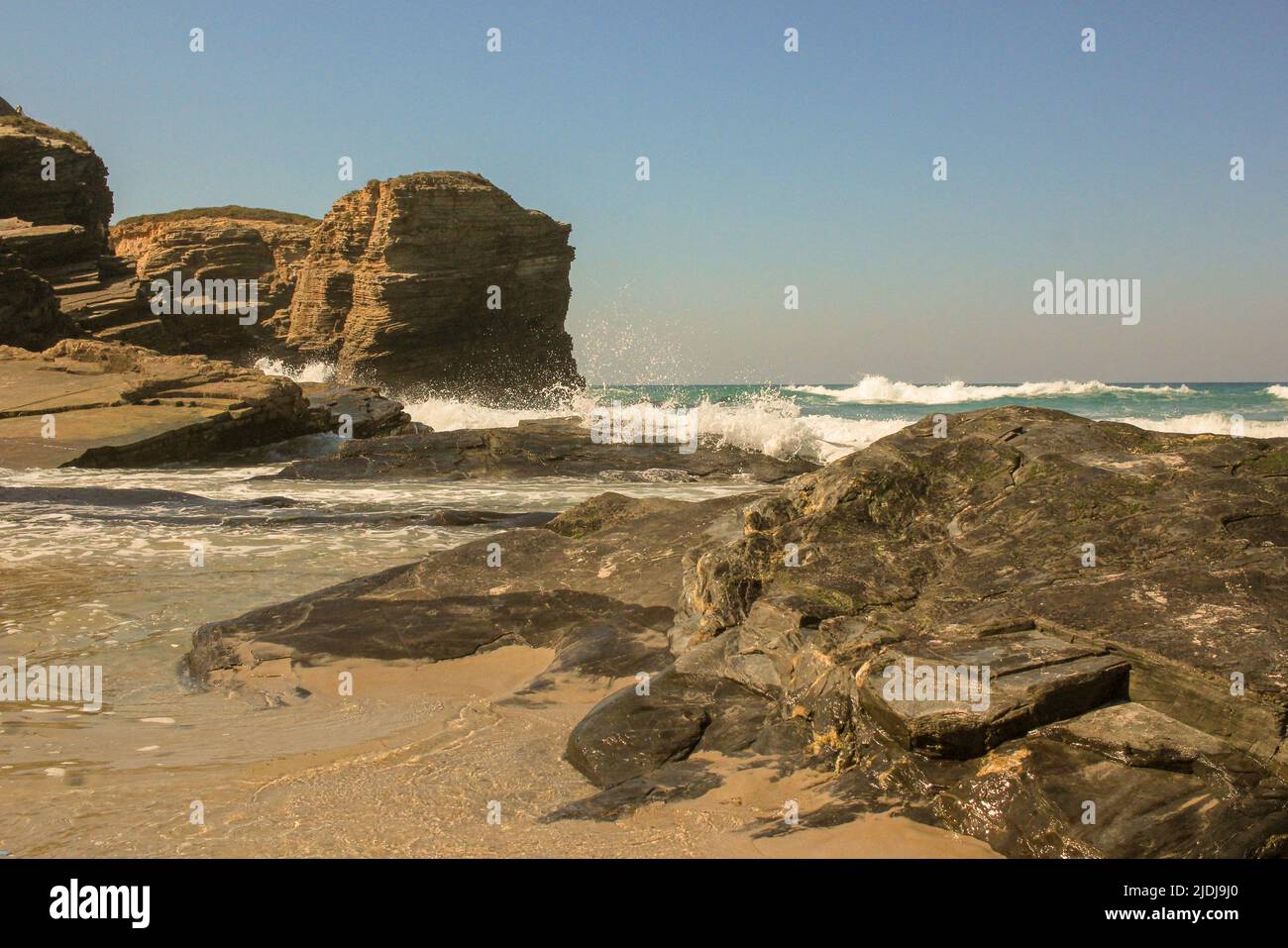 a day on the beach among the rocks and cold water Stock Photo - Alamy