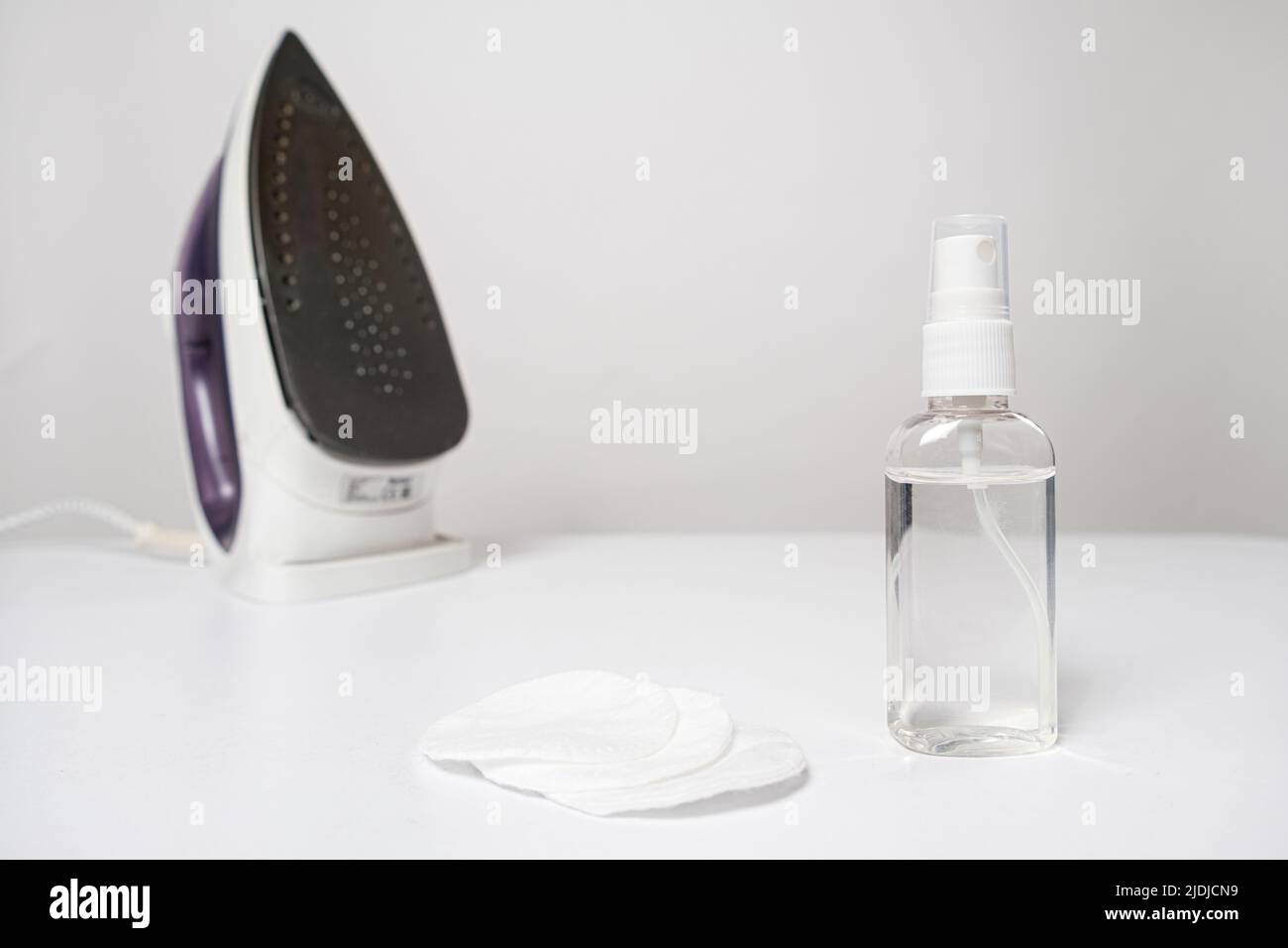 Means for cleaning the iron in a bottle on a white background. Cleaning ...
