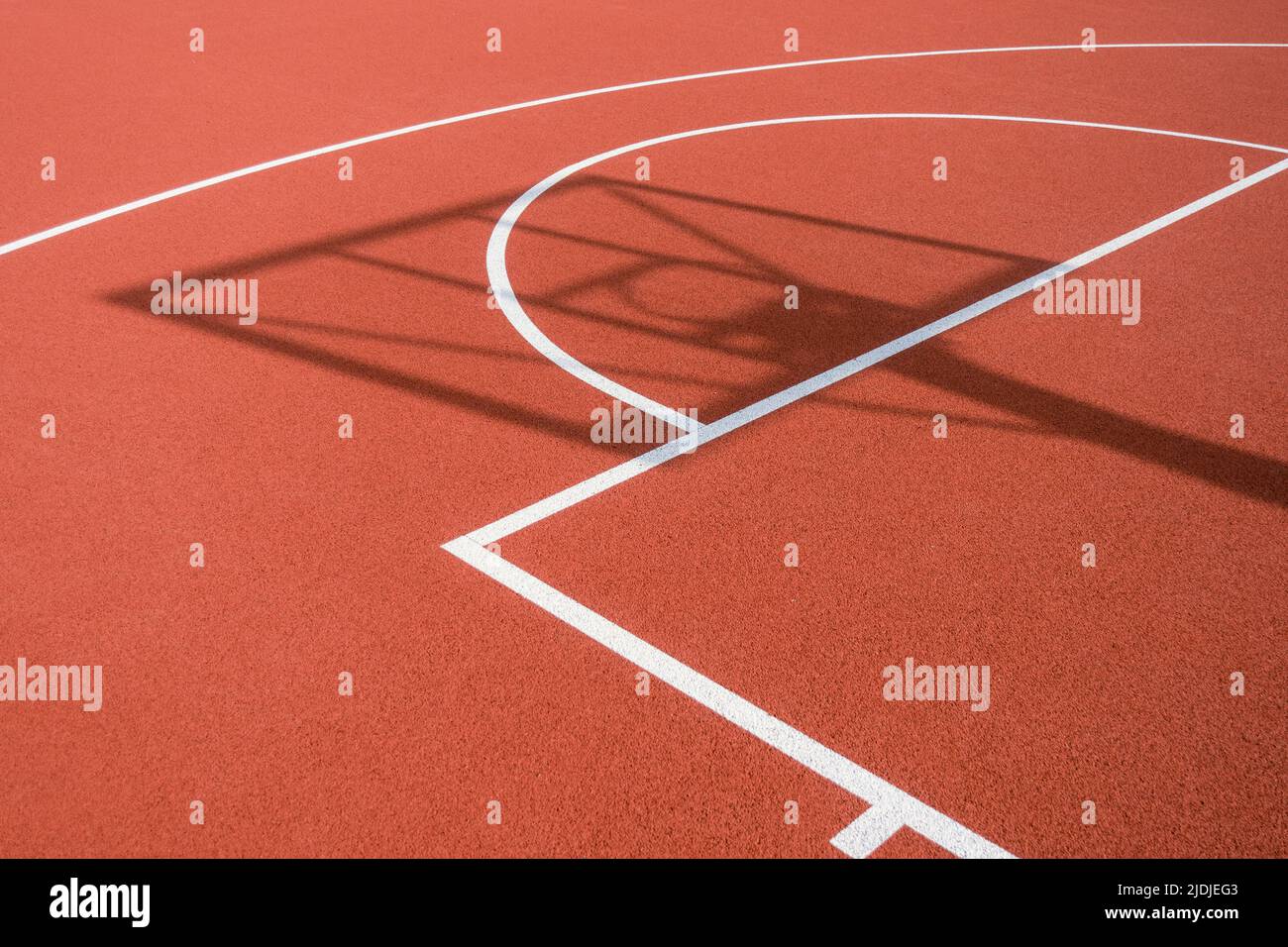 Shadow of the rack with shield and basketball ring on orange basketball ...